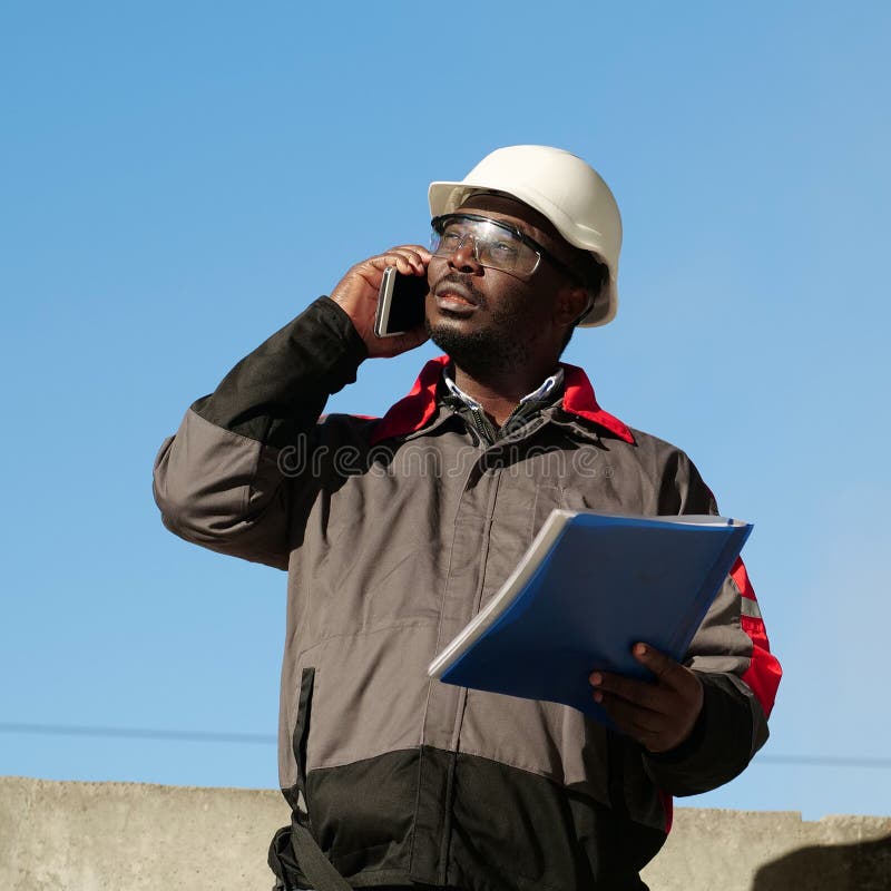 African American Builder with Work Papers Talks on Smartphone Stock ...