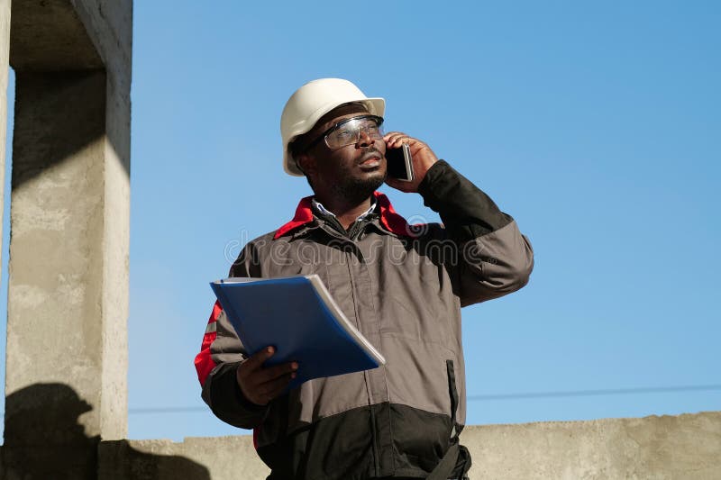 African American Builder with Work Papers Talks on Smartphone Stock ...