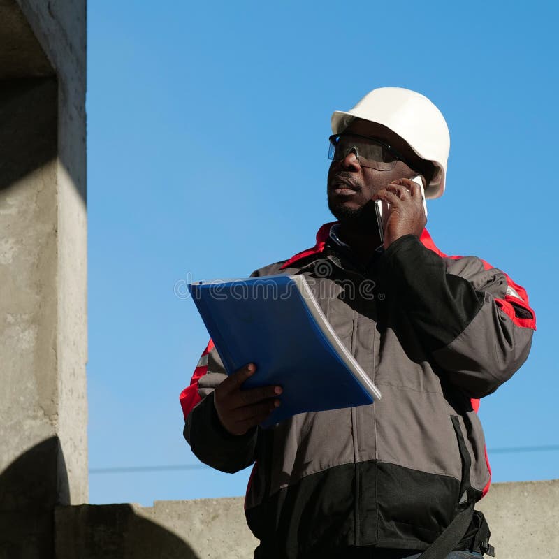 African American Builder with Work Papers Talks on Smartphone Stock ...