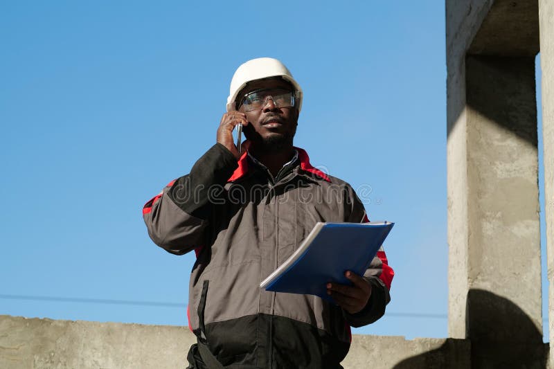 African American Builder with Work Papers Talks on Smartphone Stock ...