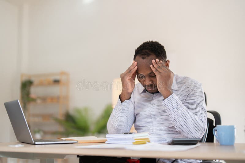 African American Businessman Feeling Stressed while Working on Laptop ...