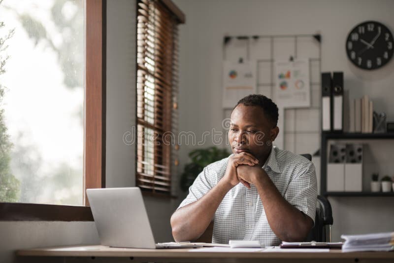 African American Businessman Feeling Stressed while Working Using ...
