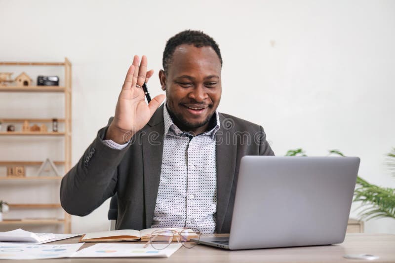 African American Businessman Using His Laptop Computer while Working ...
