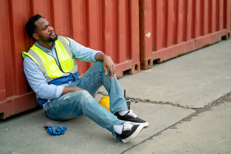 African American Cargo Container Worker or Technician Sit and Lean on ...