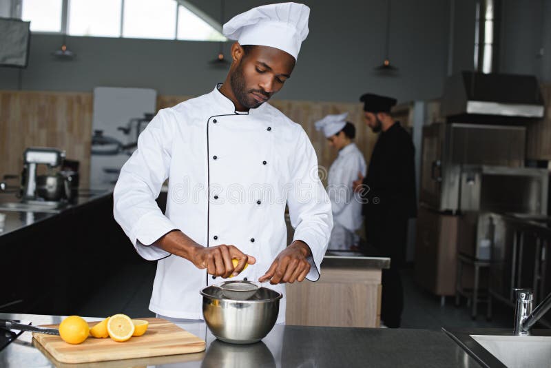 African American Chef Squeezing Lemons Stock Photo - Image of workplace ...
