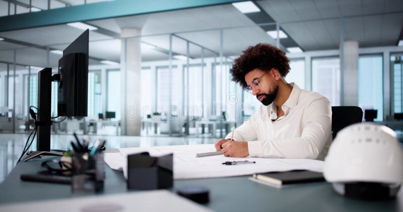 African-American Civil Engineer Creating Construction Plans on Computer ...