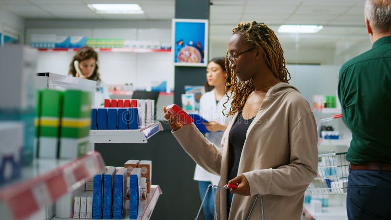 African American Client Reading Vitamins Leaflet and Checking Drugs ...