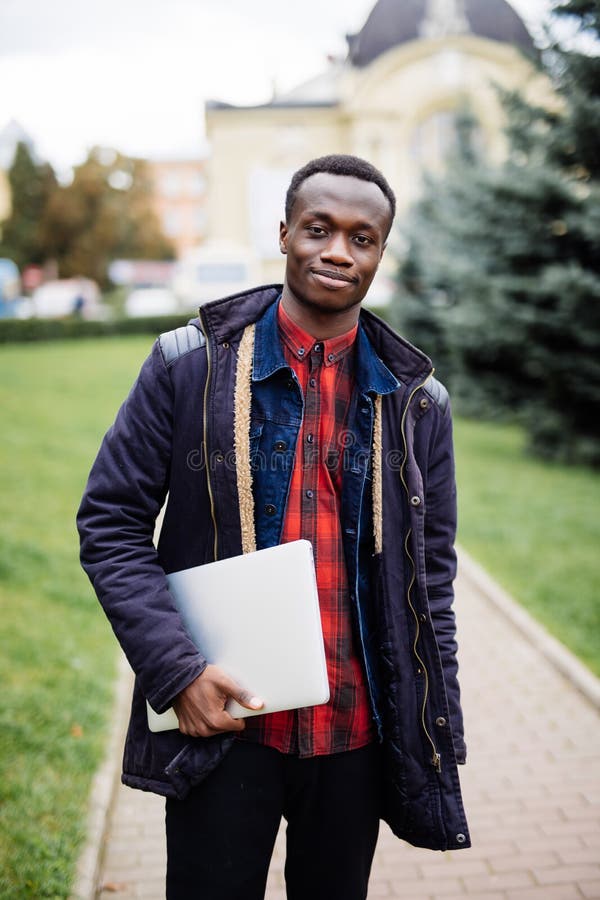 African American College Student with Laptop Computer, Thinking. Stock ...