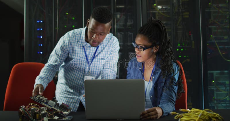 African American Computer Technicians Using Tablet Working in Business ...