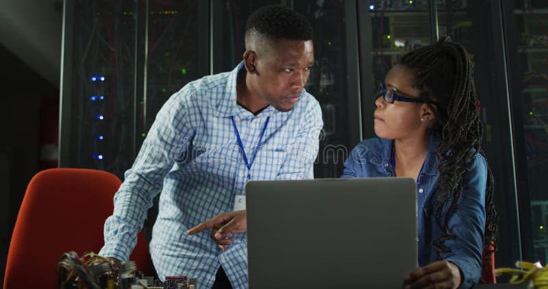 African American Computer Technicians Using Tablet Working in Business ...