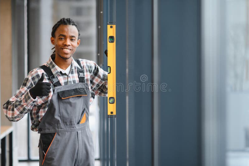 African American Construction Worker Checking Alignment with Spirit ...