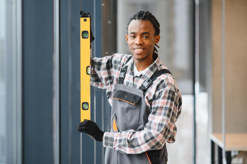 African American Construction Worker Checking Alignment with Spirit ...