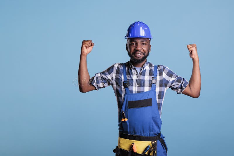 Builder Wearing Overalls Proud of Arm Muscles Stock Photo - Image of ...