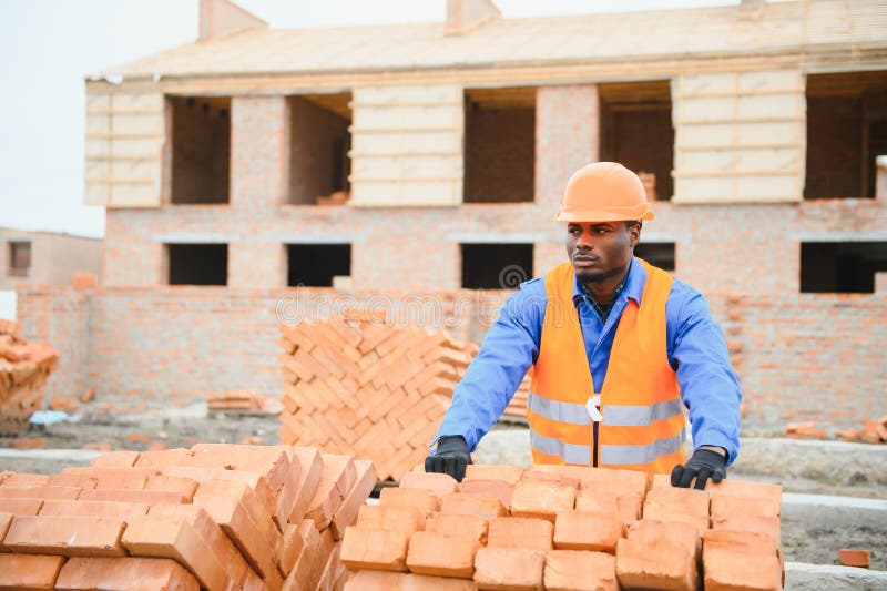 An African American Construction Worker, in Work Clothes and a Hard Hat ...