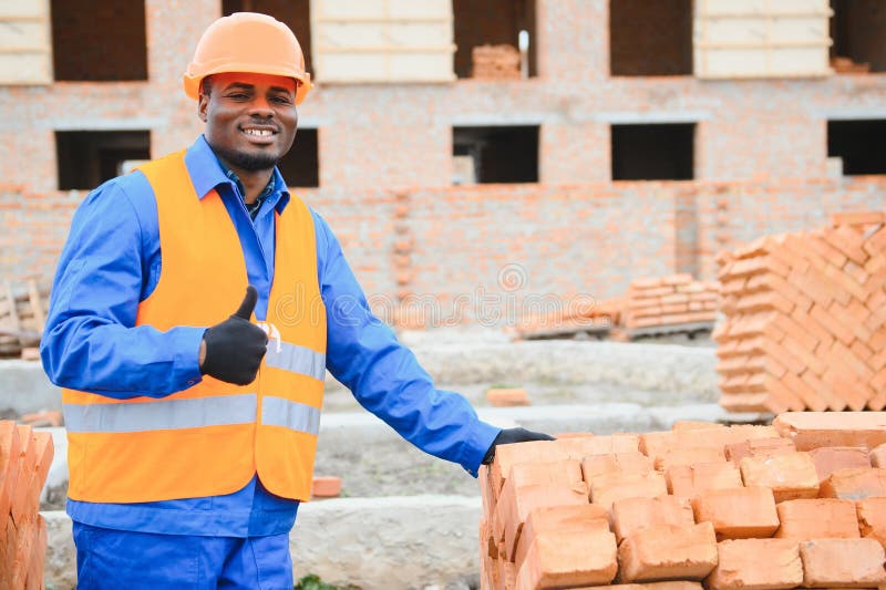 An African American Construction Worker, in Work Clothes and a Hard Hat ...