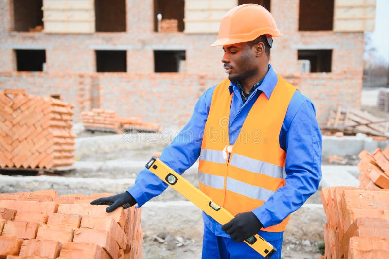 An African American Construction Worker, in Work Clothes and a Hard Hat ...