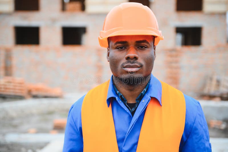An African American Construction Worker, in Work Clothes and a Hard Hat ...
