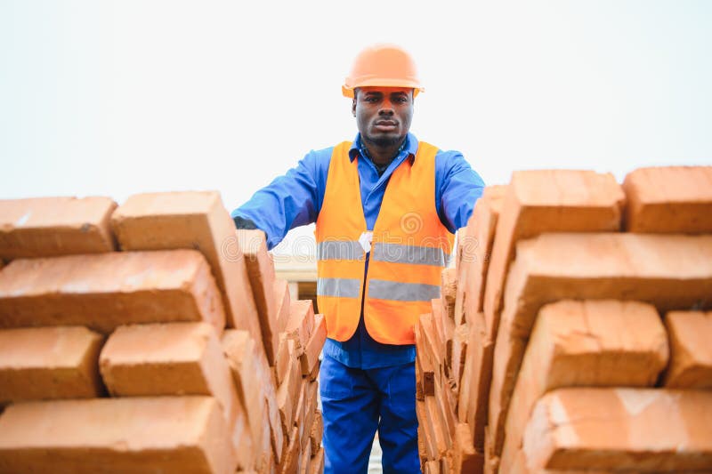 An African American Construction Worker, in Work Clothes and a Hard Hat ...