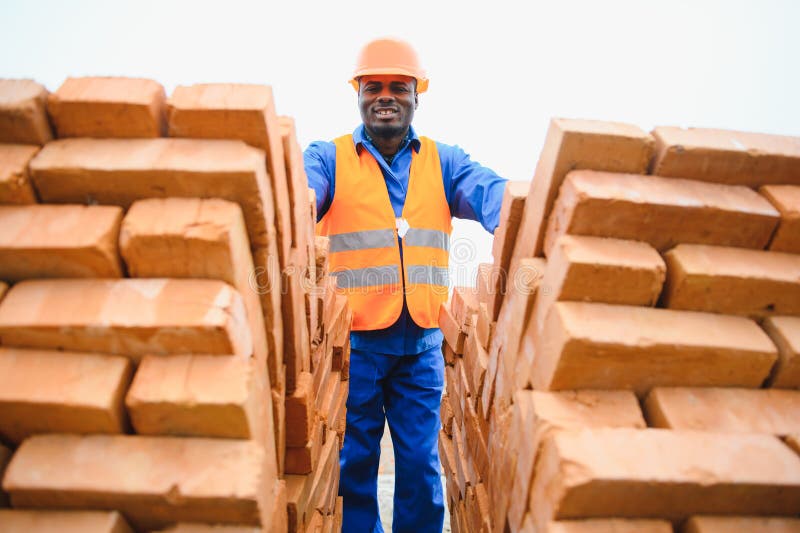 An African American Construction Worker, in Work Clothes and a Hard Hat ...