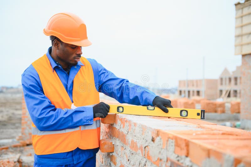 An African American Construction Worker, in Work Clothes and a Hard Hat ...