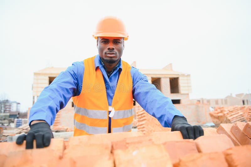An African American Construction Worker, in Work Clothes and a Hard Hat ...