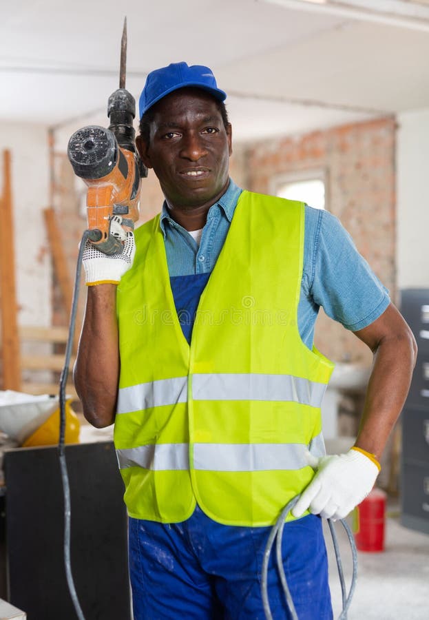 African American Contractor Standing with Chipping Chisel at ...
