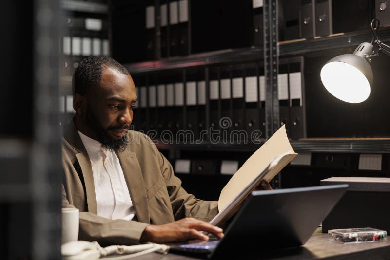 African American Cop Reading Case File, Analyzing Witness Statement ...