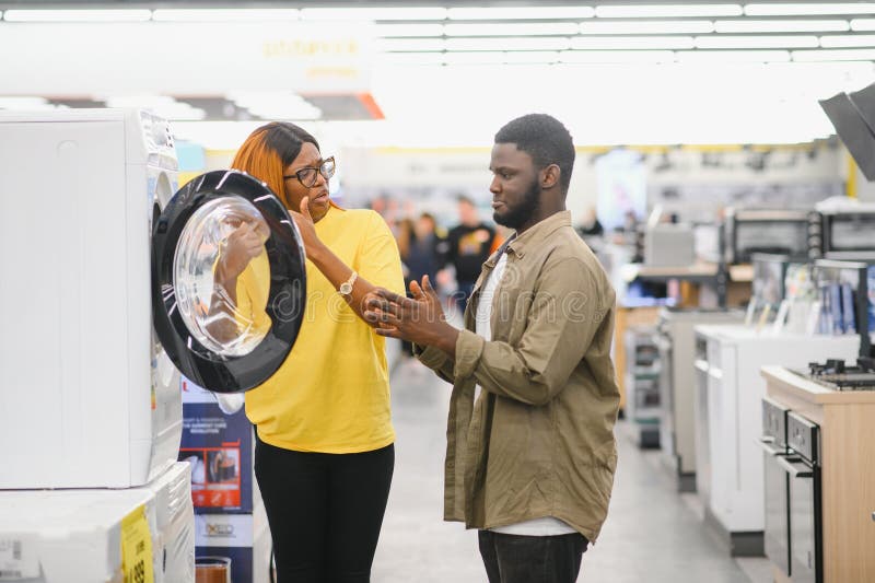 African American Couple Choosing Washing Machine at Electronics Store ...