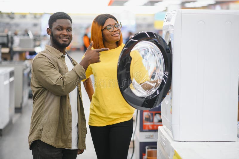 African American Couple Choosing Washing Machine, Electronics Store ...
