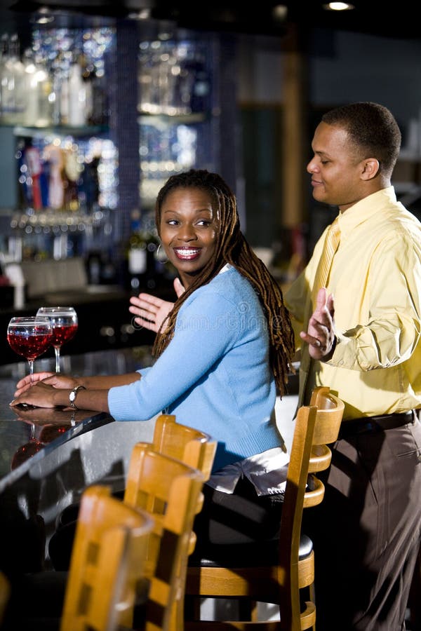 African American Couple Enjoying Drinks at Bar Stock Image - Image of ...
