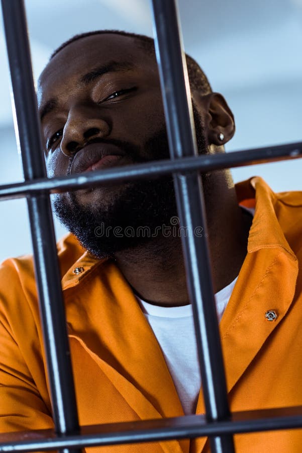 African American Criminal Looking at Camera Behind Stock Photo - Image ...