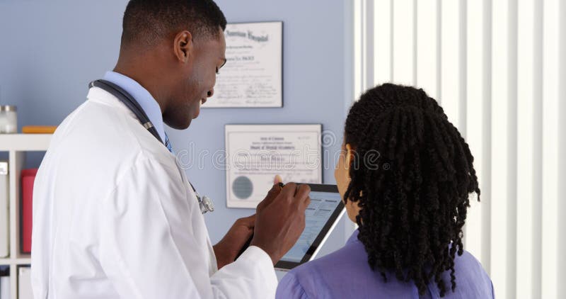 African American Doctor Taking Patient History with Tablet Stock Image ...