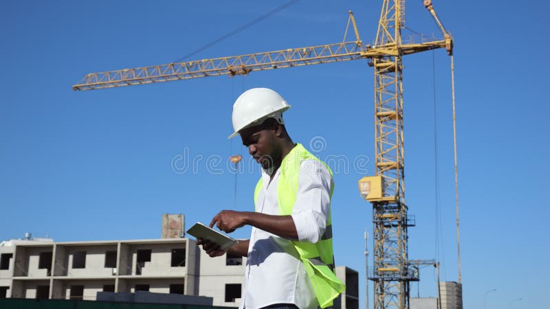 African American Man Types Report about Building at Sunlight Stock ...