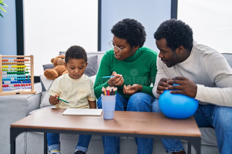 African American Family Drawing on Notebook Sitting on Floor at Home ...