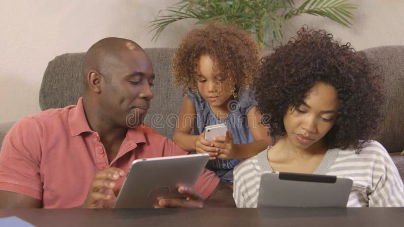 African American Family Using Cellphone and Tablets Stock Video - Video ...