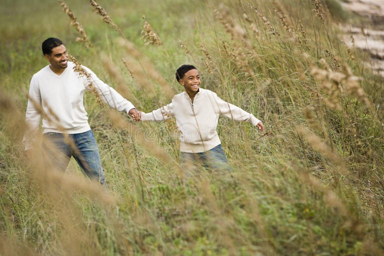 African-American Father and Son Walking Stock Image - Image of grass ...