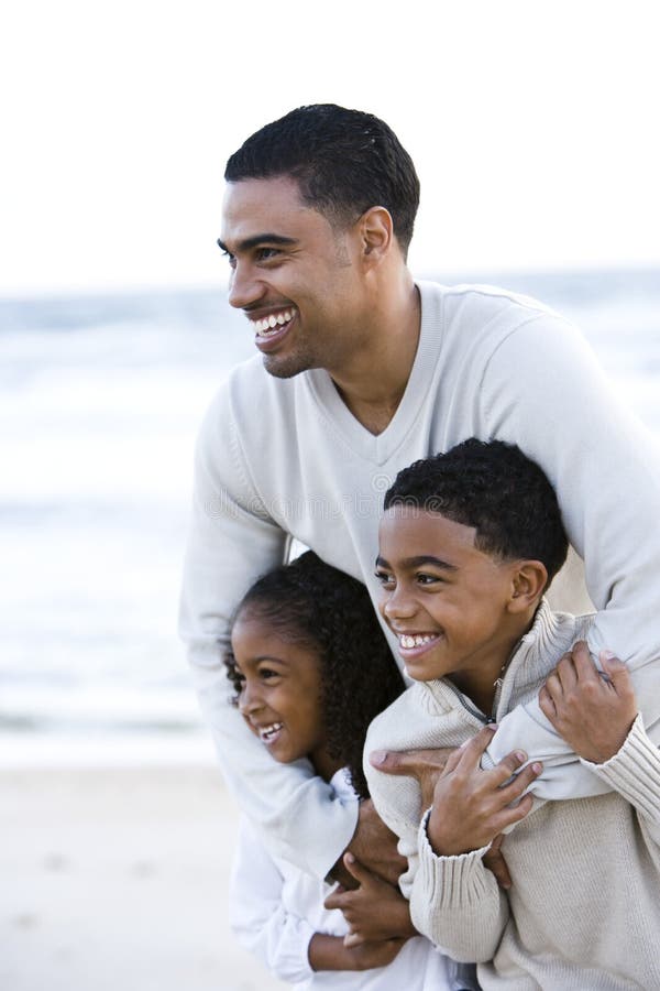 Happy African-American Family Playing on Beach Stock Image - Image of ...