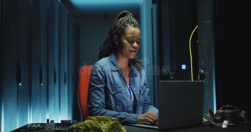 African American Female Computer Technician Using Tablet Working in ...