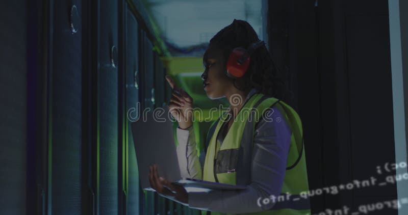 African American Female Server Room Worker Using Headphones Stock Image ...