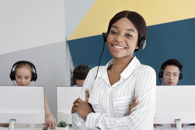 African American Female Tech Support Operator Looking at Camera and ...