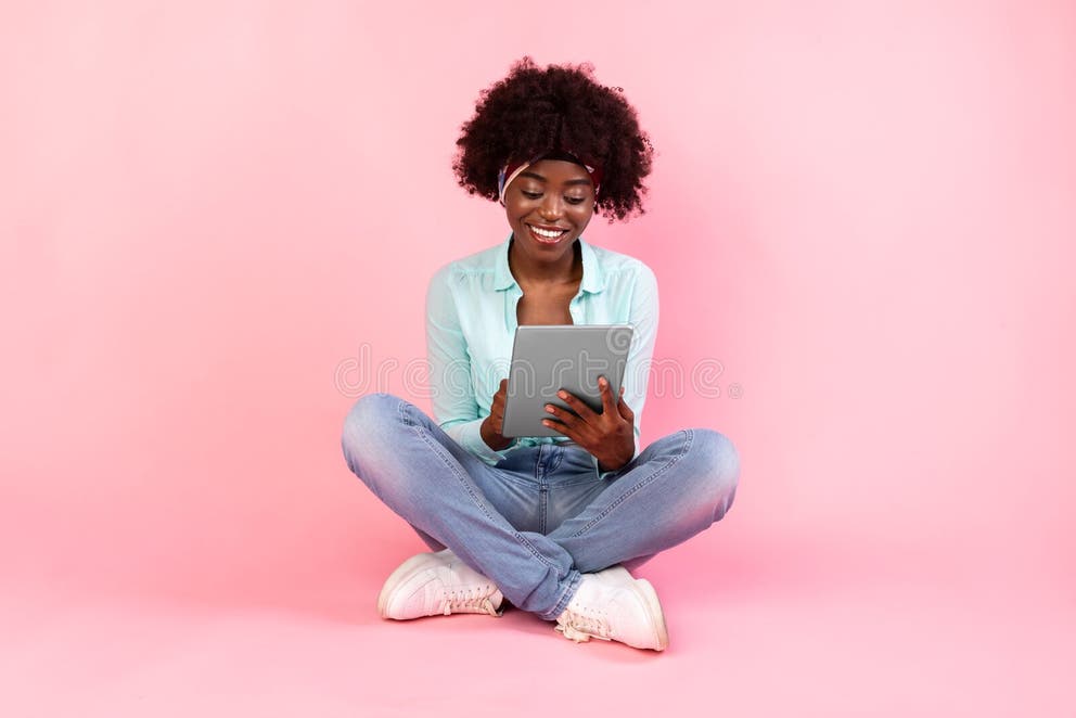 African American Female Using Tablet Computer Browsing Internet, Pink ...