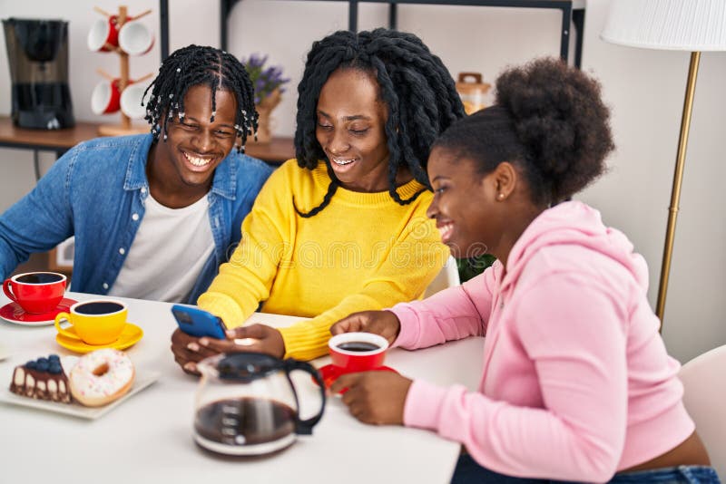 African American Friends Having Breakfast and Using Smartphone at Home ...
