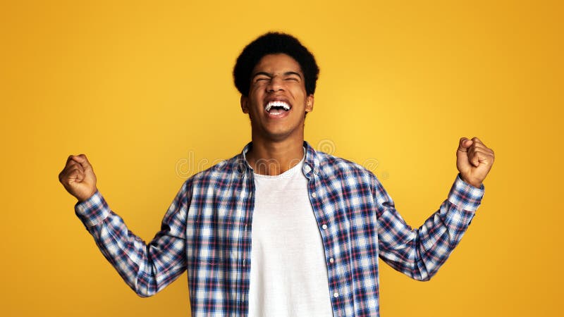 African-american Guy Celebrating Victory Over Orange Background Stock ...