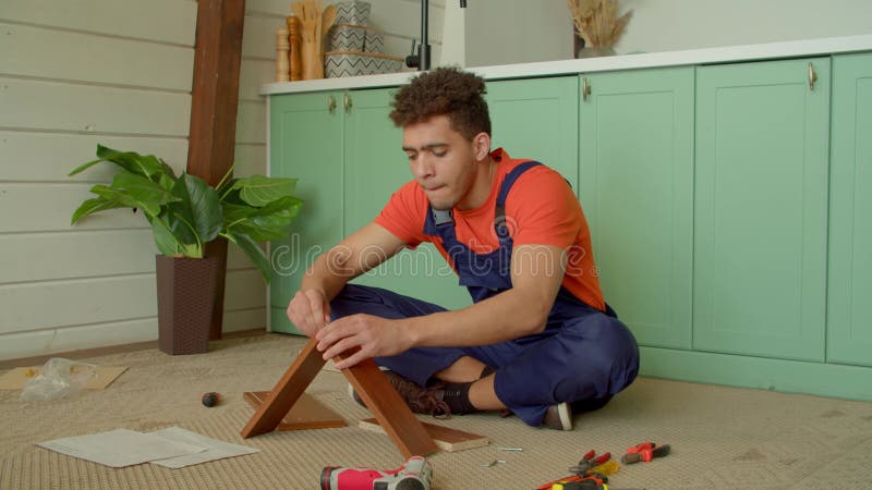 African American Handyman Assembling DIY Drawer of Bedside Table Using ...