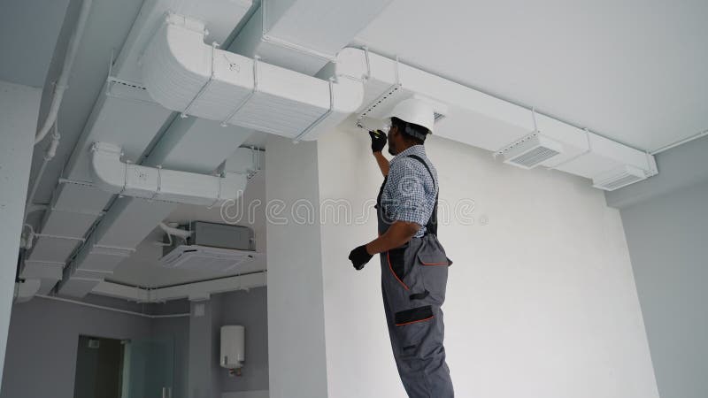 African American HVAC Technician Worker Testing Newly Installed ...
