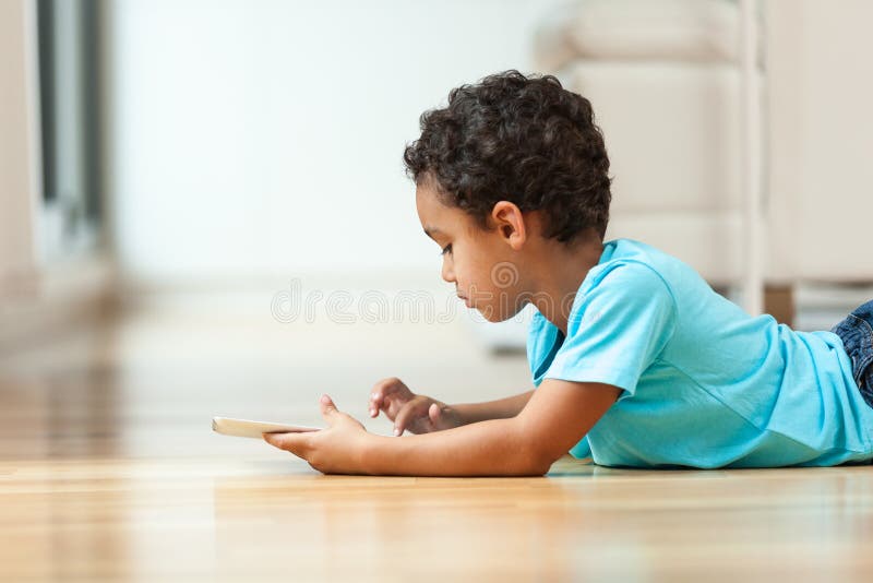 African American Little Boy Using a Tactile Tablet Stock Image - Image ...