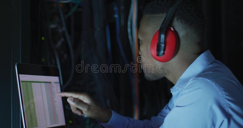 African American Male Computer Technician Using Laptop Working in ...