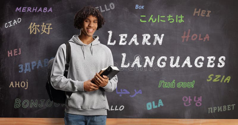 African American Male Student Holding Books in Front of a Blackboard ... African American Male Student Holding Books in Front of a Blackboard ...