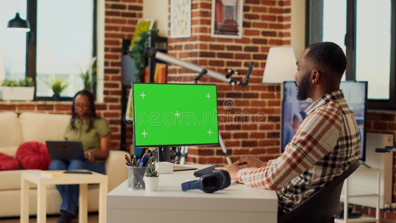 African American Man Analyzing Greenscreen Display on Computer Stock ...