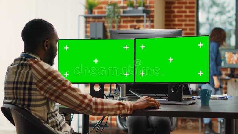 African American Man Analyzing Greenscreen on Multi Monitors Stock ...